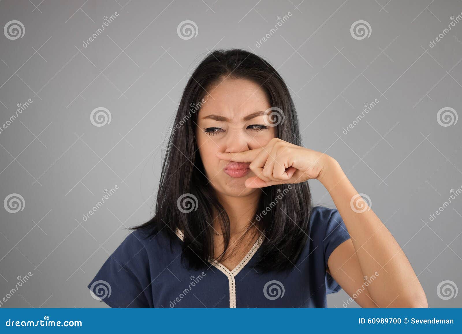 Asian Woman Smells Something. Stock Photo - Image of faces, adult: 60989700