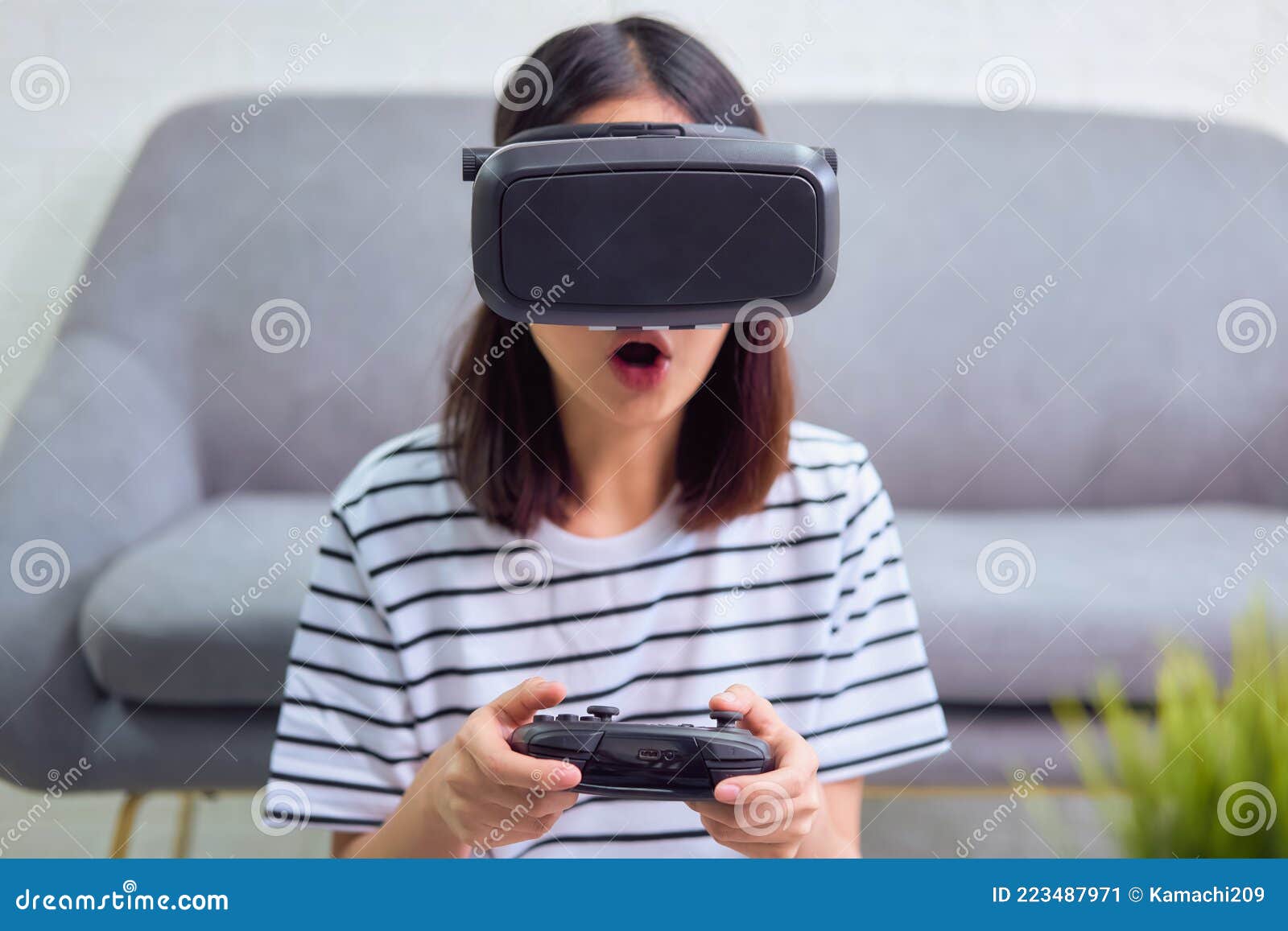 Asian Woman Using a Virtual Reality Headset and Joysticks, Concept ...