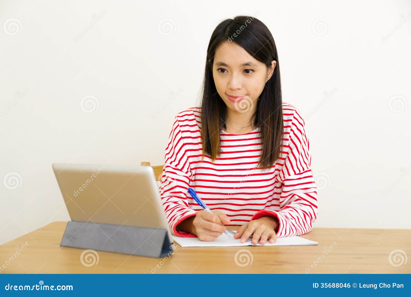 Asian Woman Writing Notes through Digital Tablet Stock Photo - Image of ...