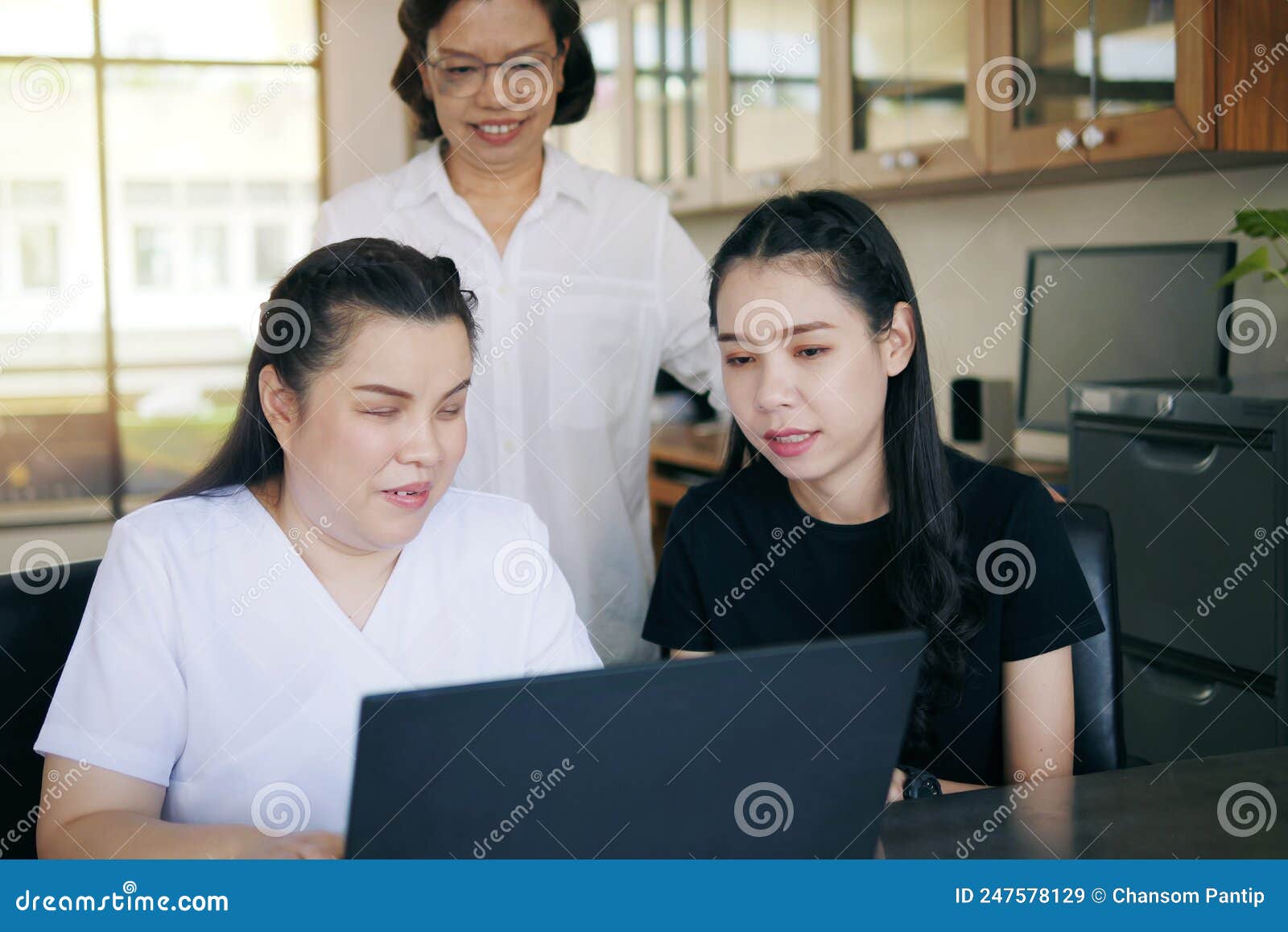 Asian Women Co-workers in Workplace Including Person with Blindness ...