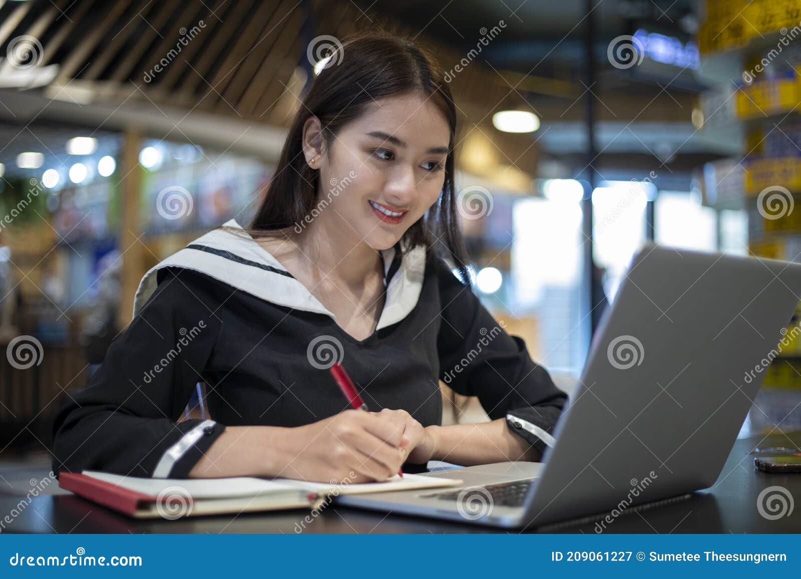 Asian Women Working and Learning Online with Computer Notebook. she ...
