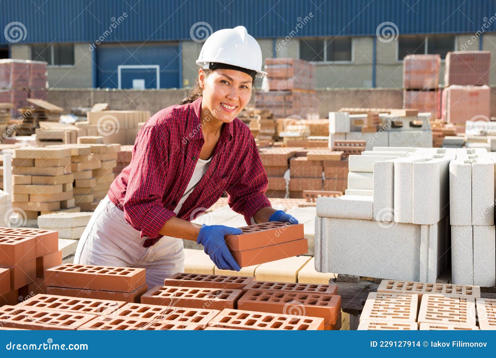 Asian Worker Stacking Bricks in Warehouse of Building Materials on an ...