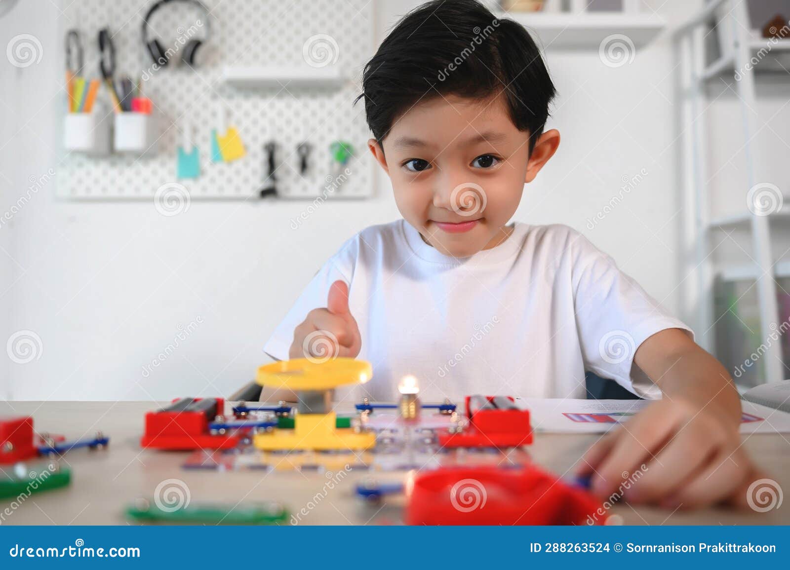 Asian Young Child Having Fun and Enjoy with Connecting Electronic Constructor. Learning and ...
