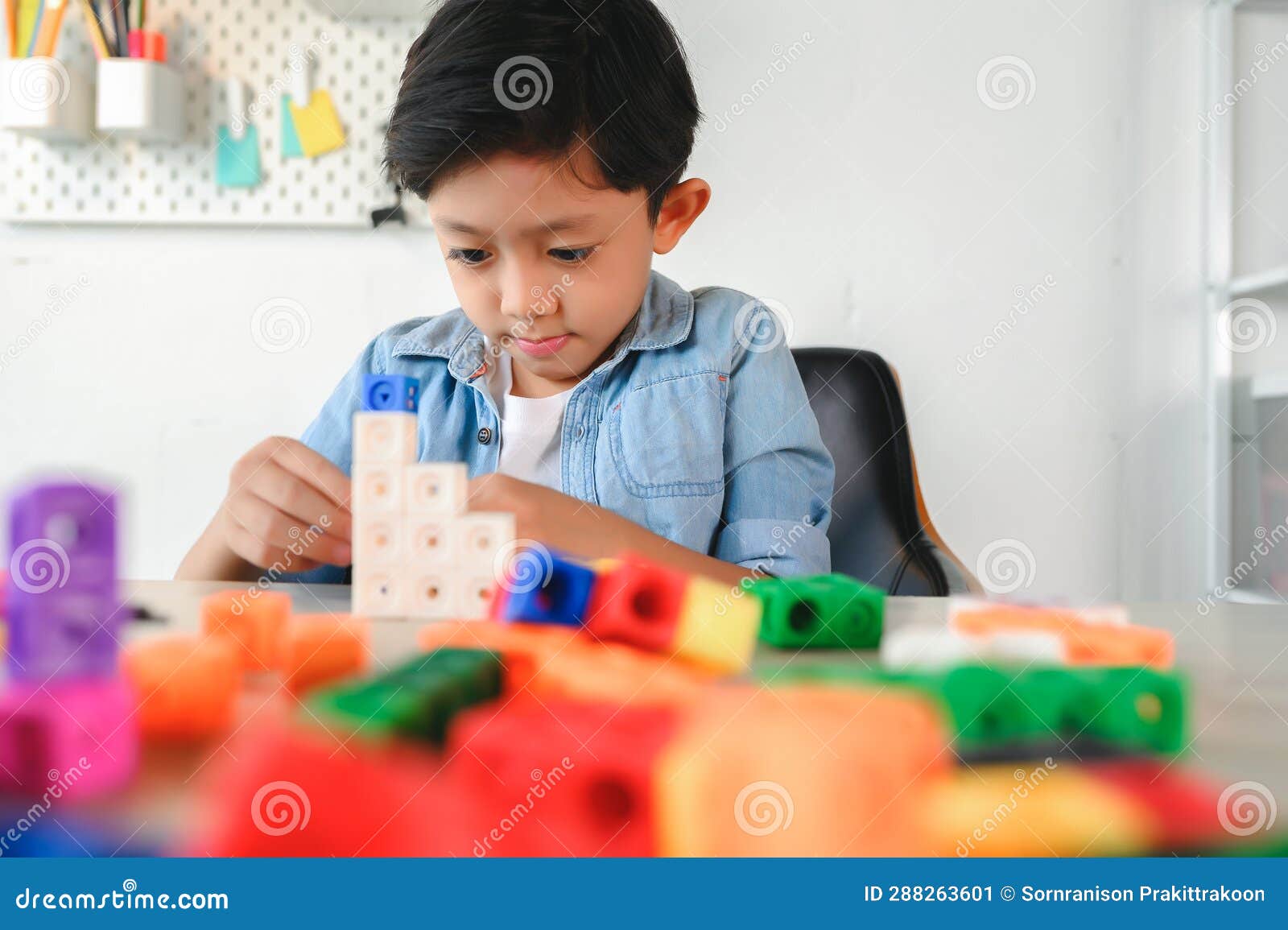 Asian Young Child Playing Colorful Plastic Cubes on Desk at Home ...