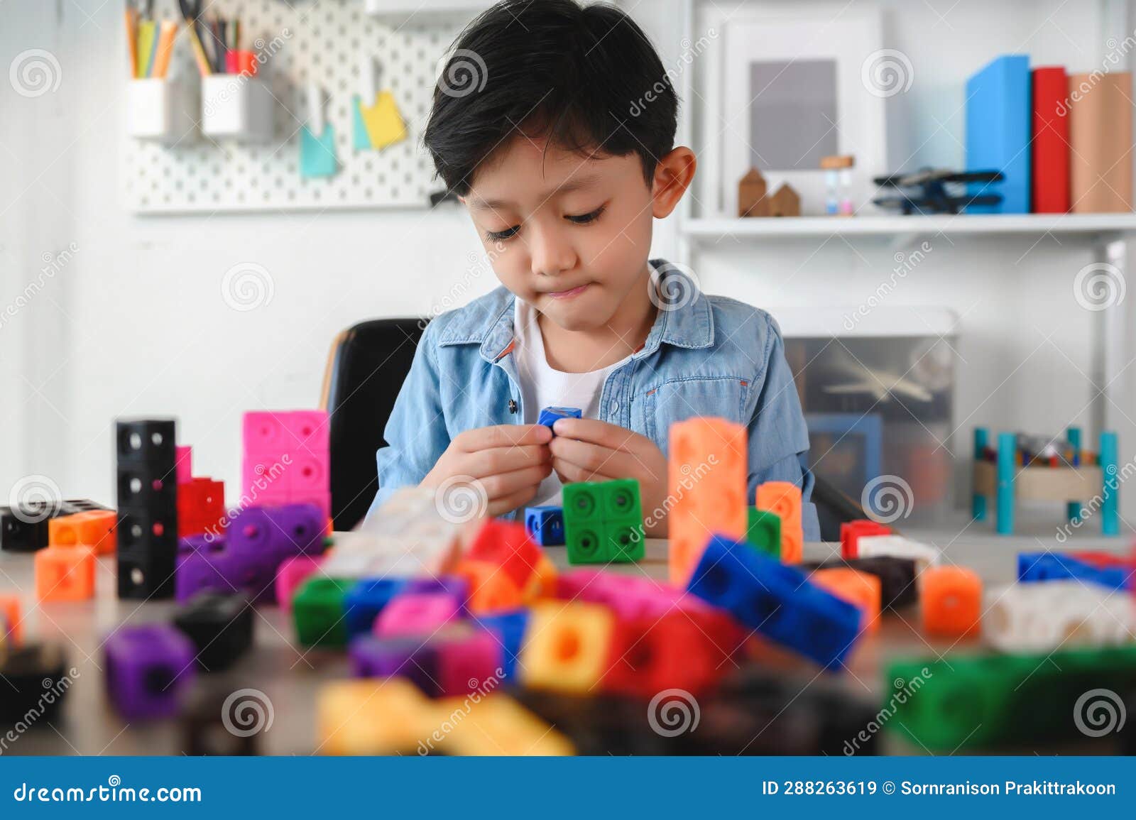 Asian Young Child Playing Colorful Plastic Cubes on Desk at Home ...