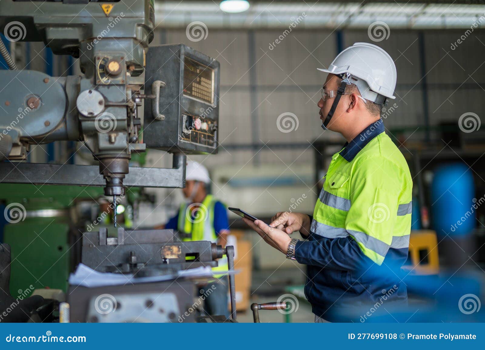 Asian Young Factory Worker Using Adept Tablet in a Workshop Building ...