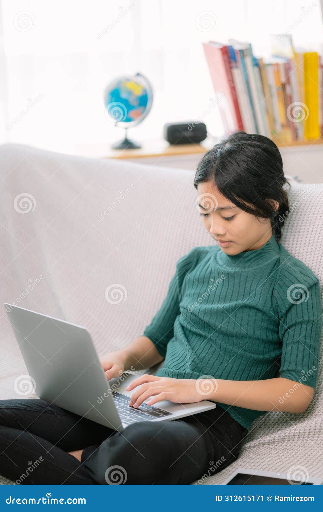 Asian Young Girls Doing Homework on Laptops on a Comfortable Couch ...