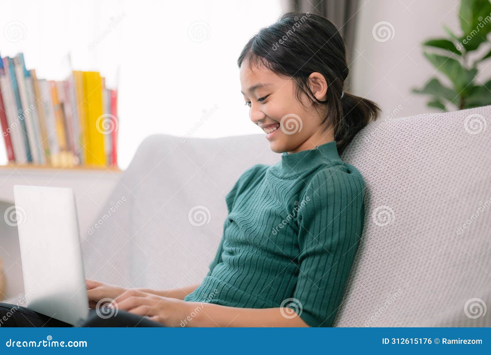 Asian Young Girls Doing Homework on Laptops on a Comfortable Couch ...