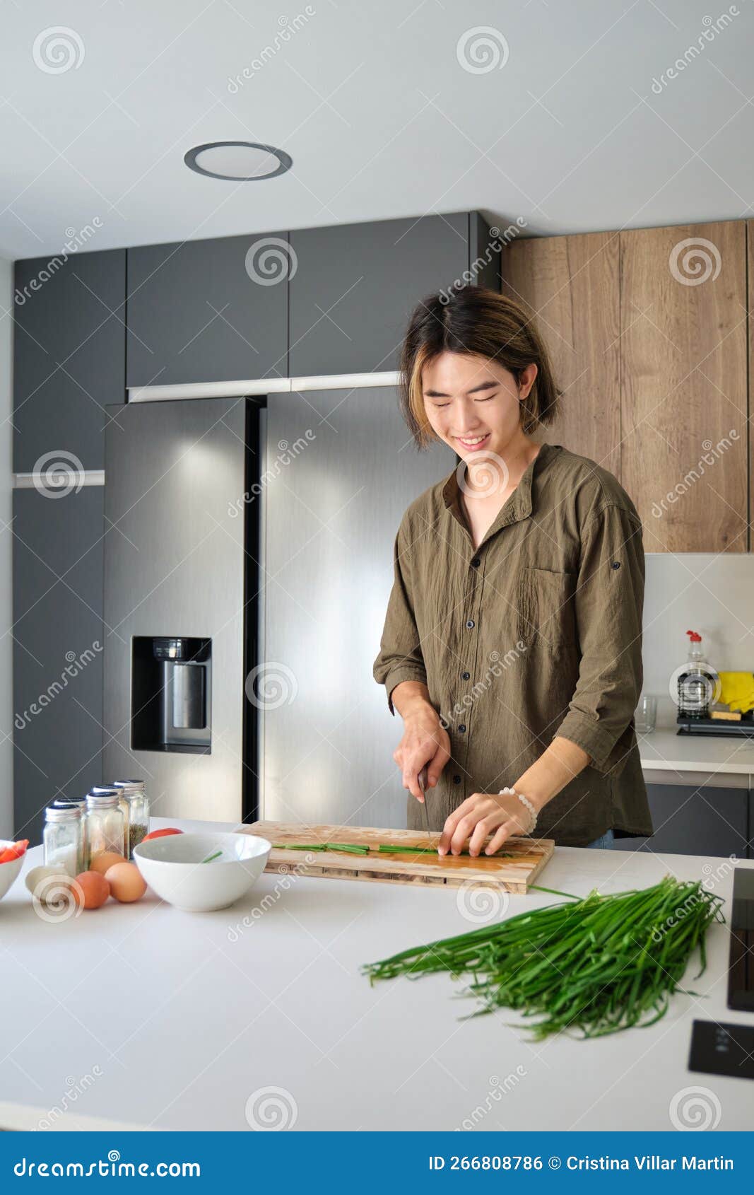 Asian Young Man Cutting Chinese Chive at Kitchen. Stock Photo - Image ...