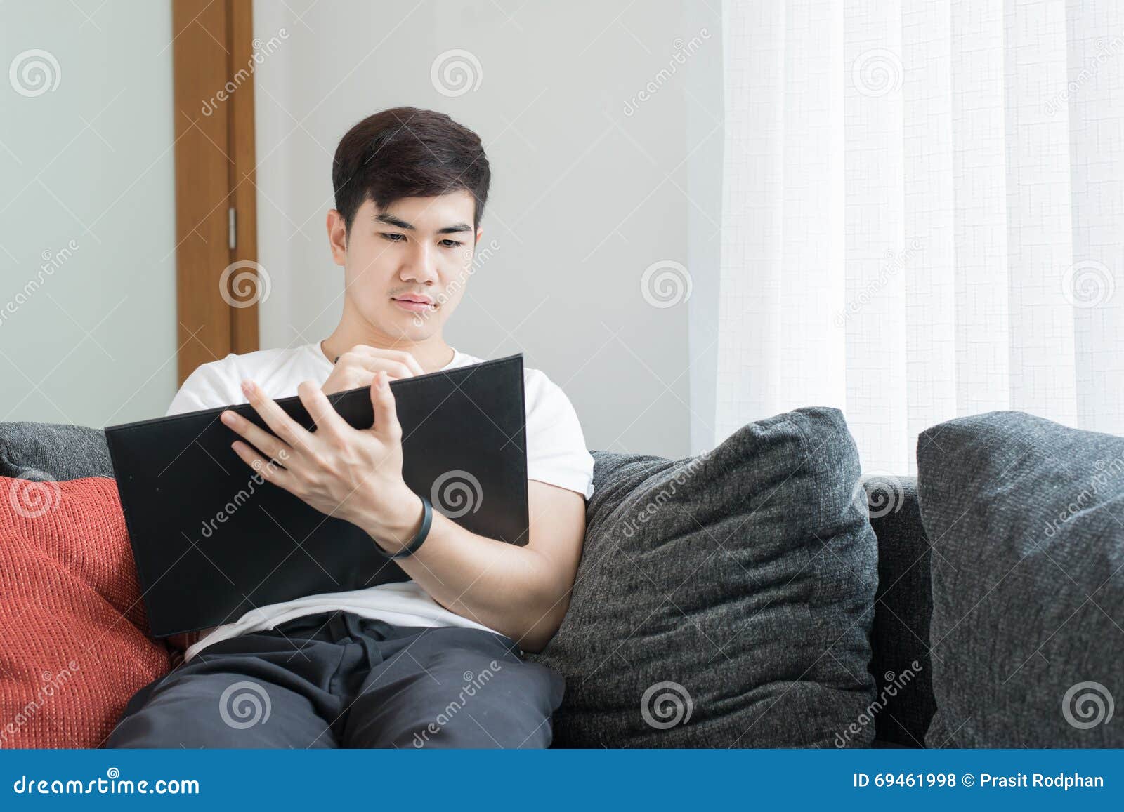 Asian Young Man Thinking and Wondering while Writing a Paper at Stock ...