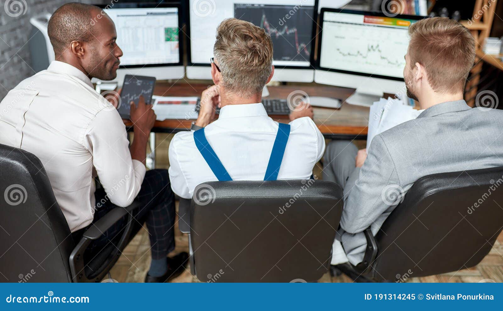 Ask. Listen. Solve. Cheerful Co-workers Traders Sitting Next To Each ...