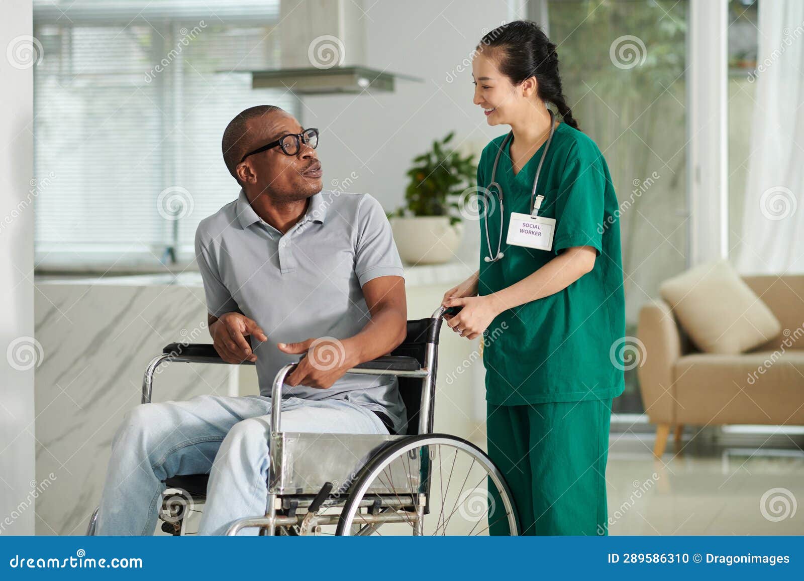 Asking Social Worker To Help with Wheelchair Stock Photo - Image of ...