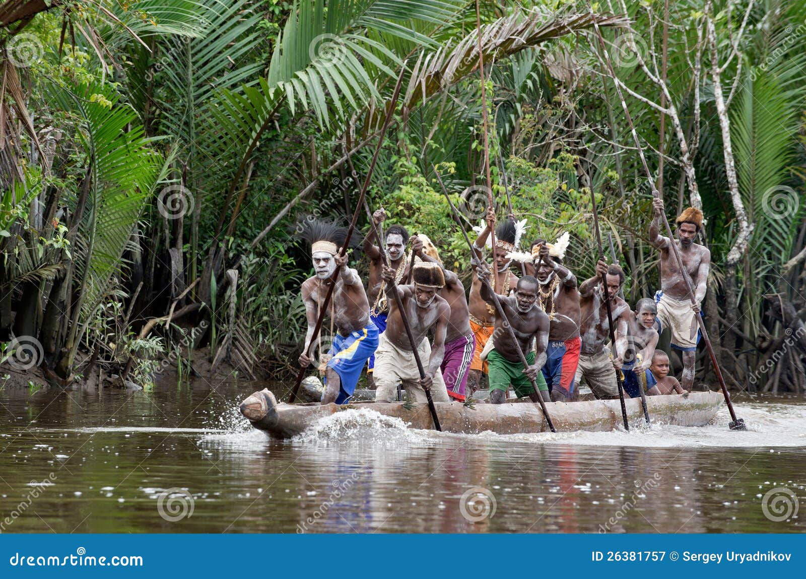 Asmat Men Paddling in Their Dugout Canoe Editorial Photography - Image ...