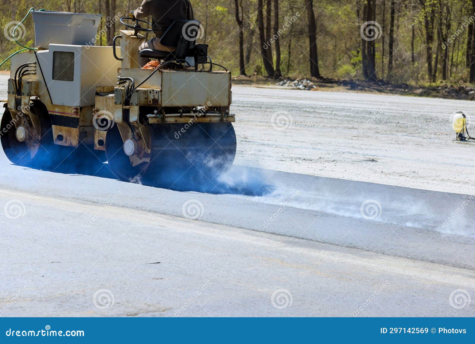 An Asphalt Roller is Used by a Worker To Lay Asphalt on New Road Stock ...