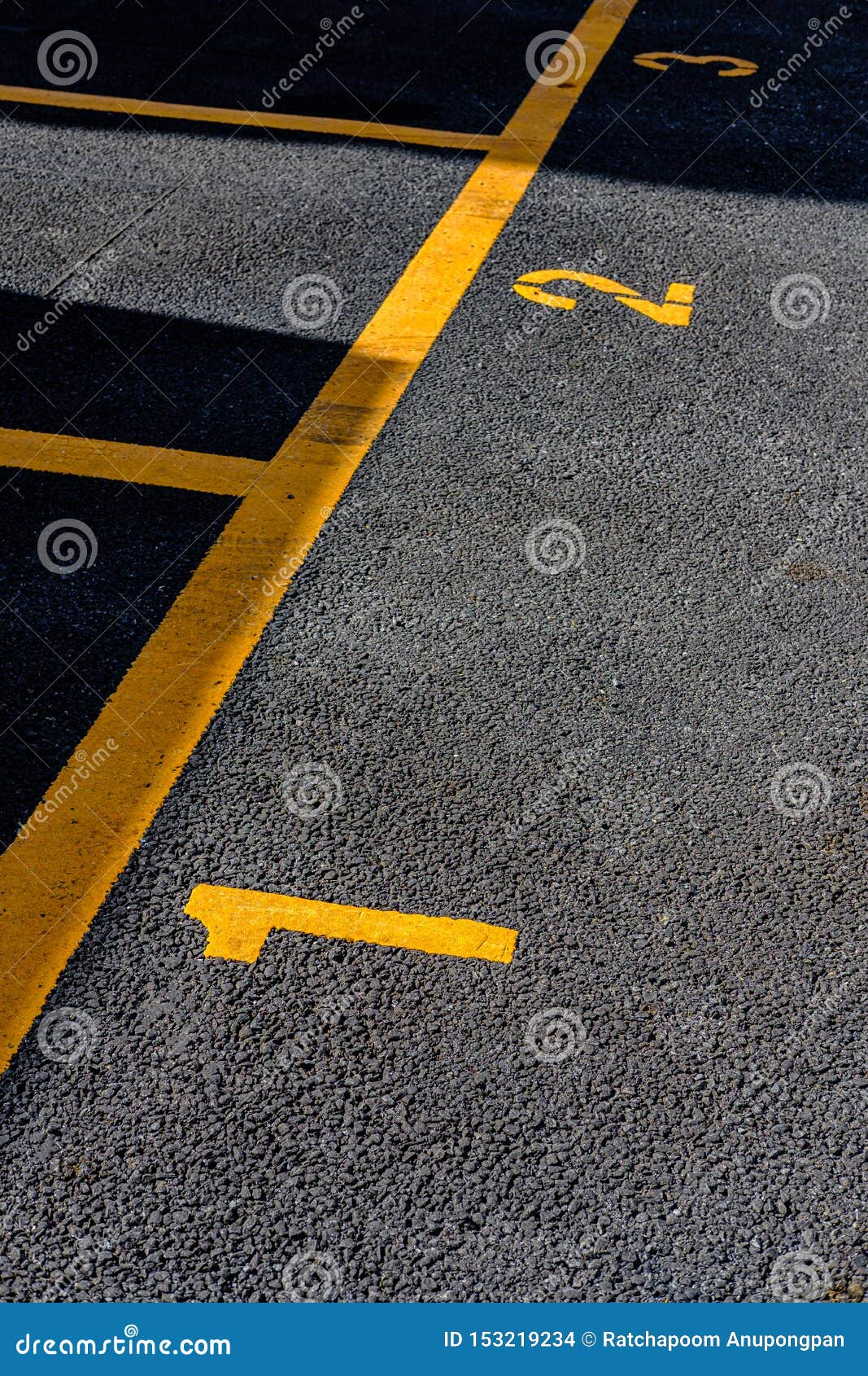 Asphalt Parking Lot with Yellow Lot Line and Yellow Lot Number 1, 2, 3 ...