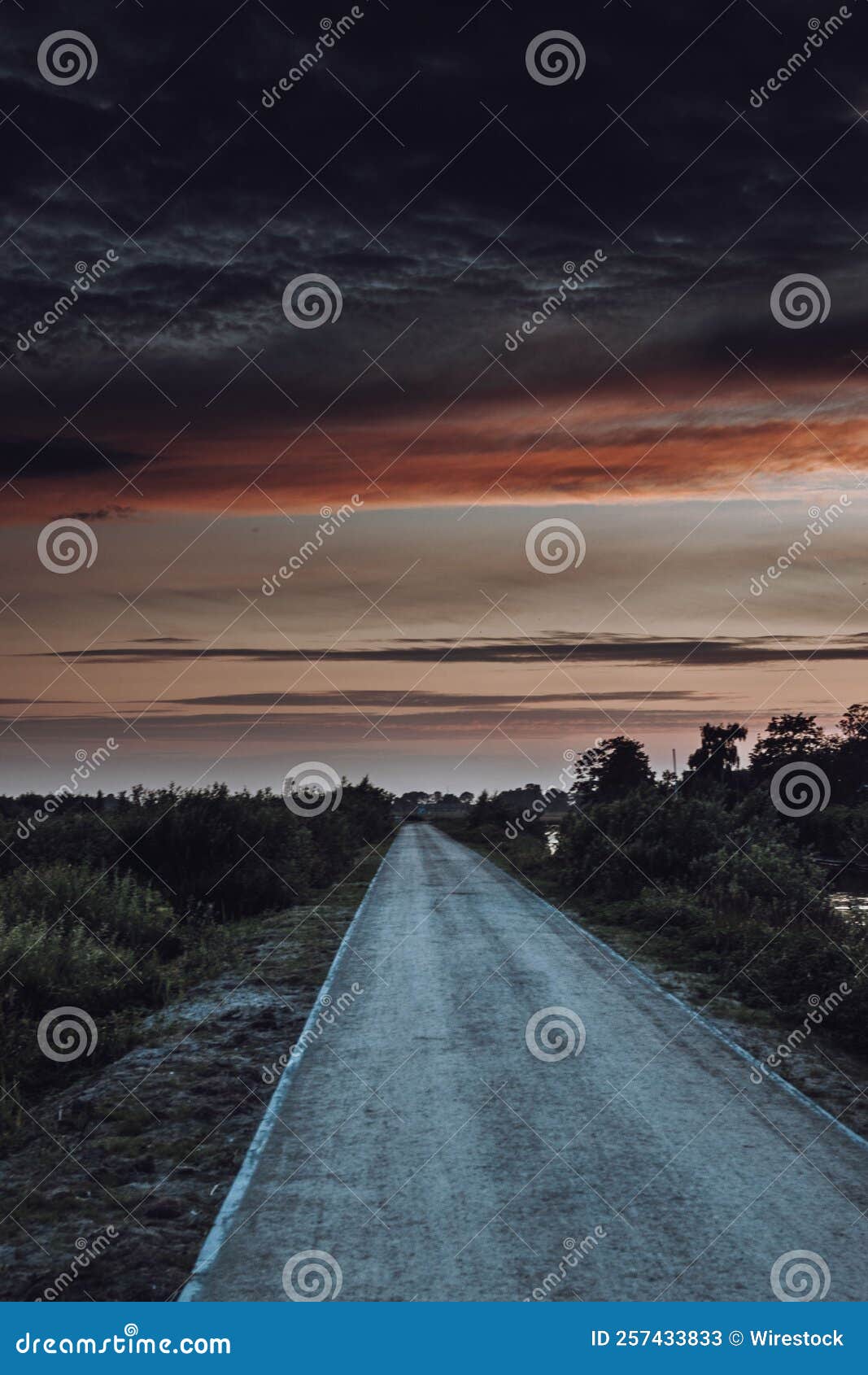 Asphalt Road Along the River during the Orange Sunset with Cloudy ...