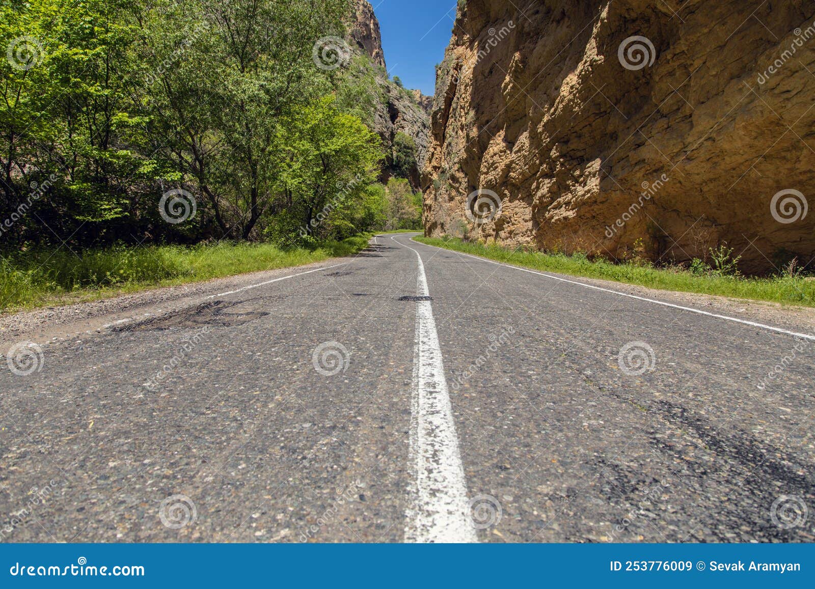 Asphalt road and rocks stock image. Image of sunset - 253776009