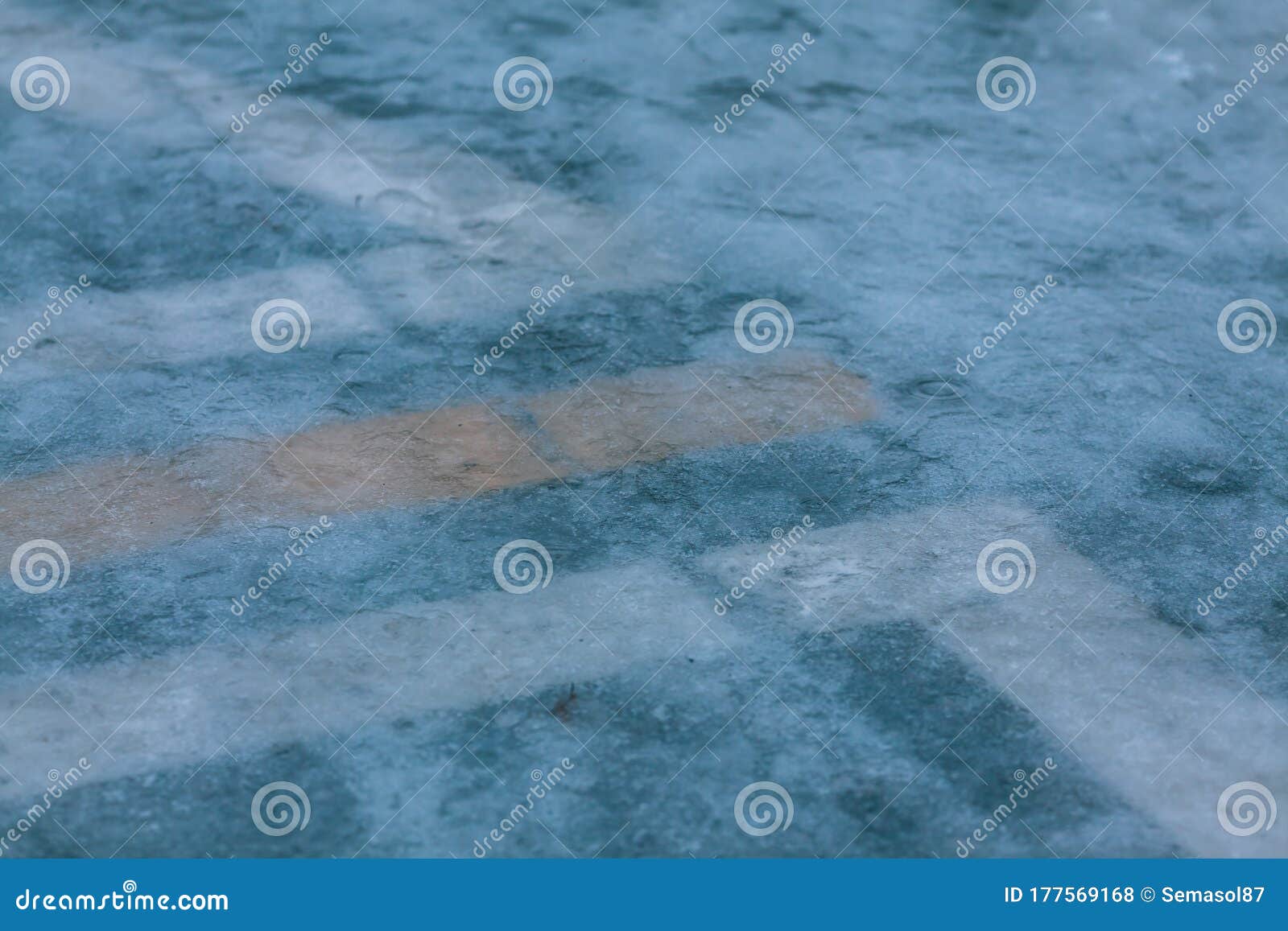 Asphalt Under the Ice. Blue Ice on Asphalt Surface and Road Markings ...