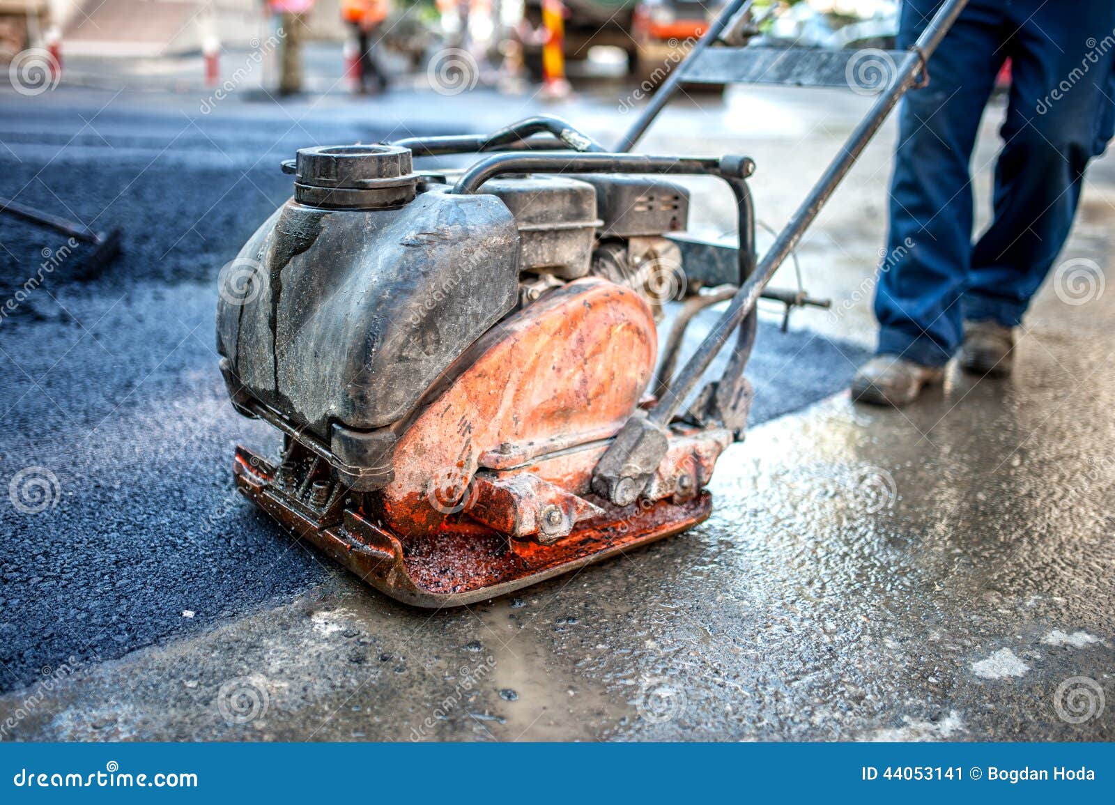 Asphalt Worker at Road Construction Site with Compactor Plate Stock ...