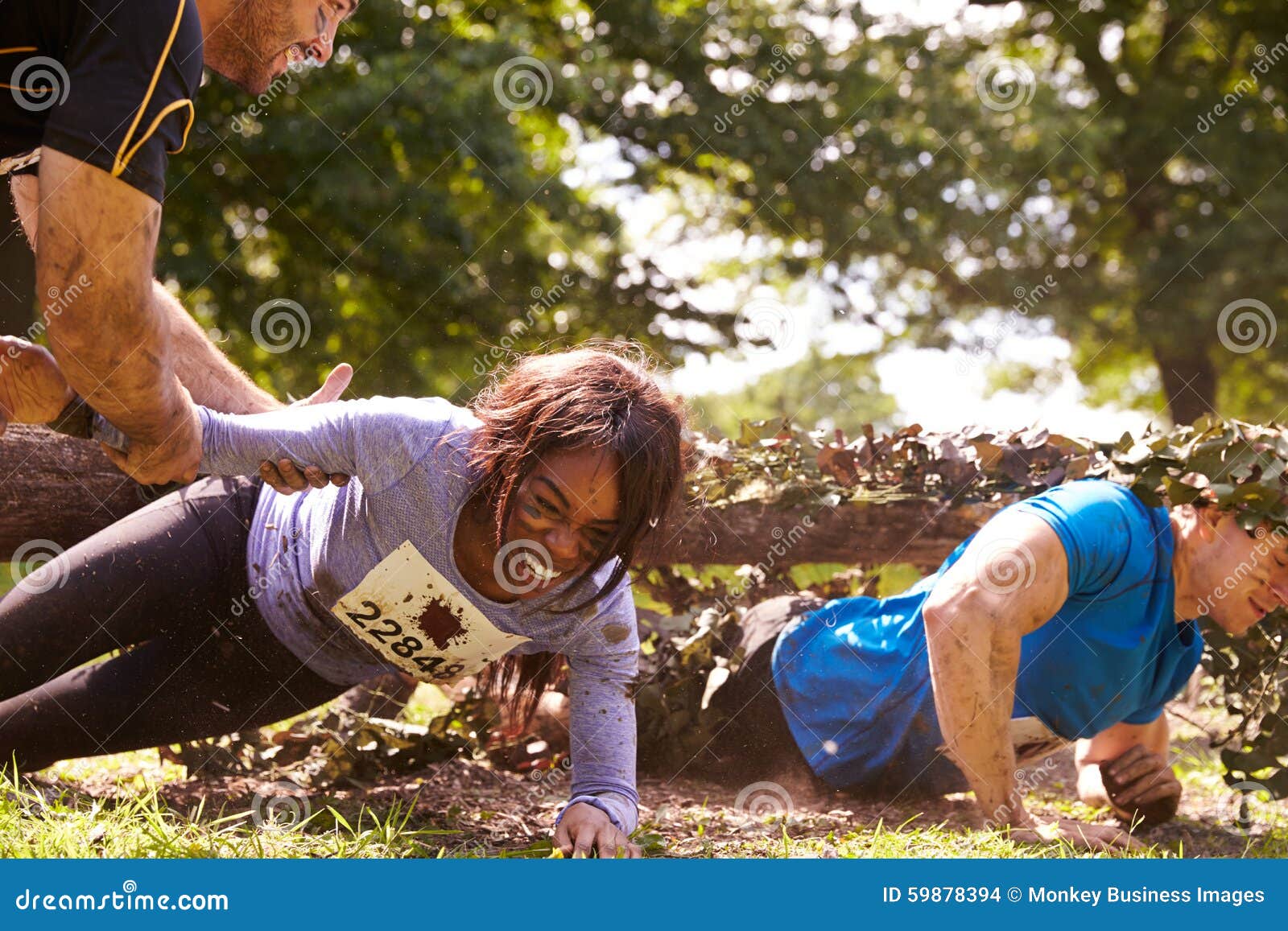 Assault Course Competitor Helping Others Crawl Under Nets Stock Photo ...