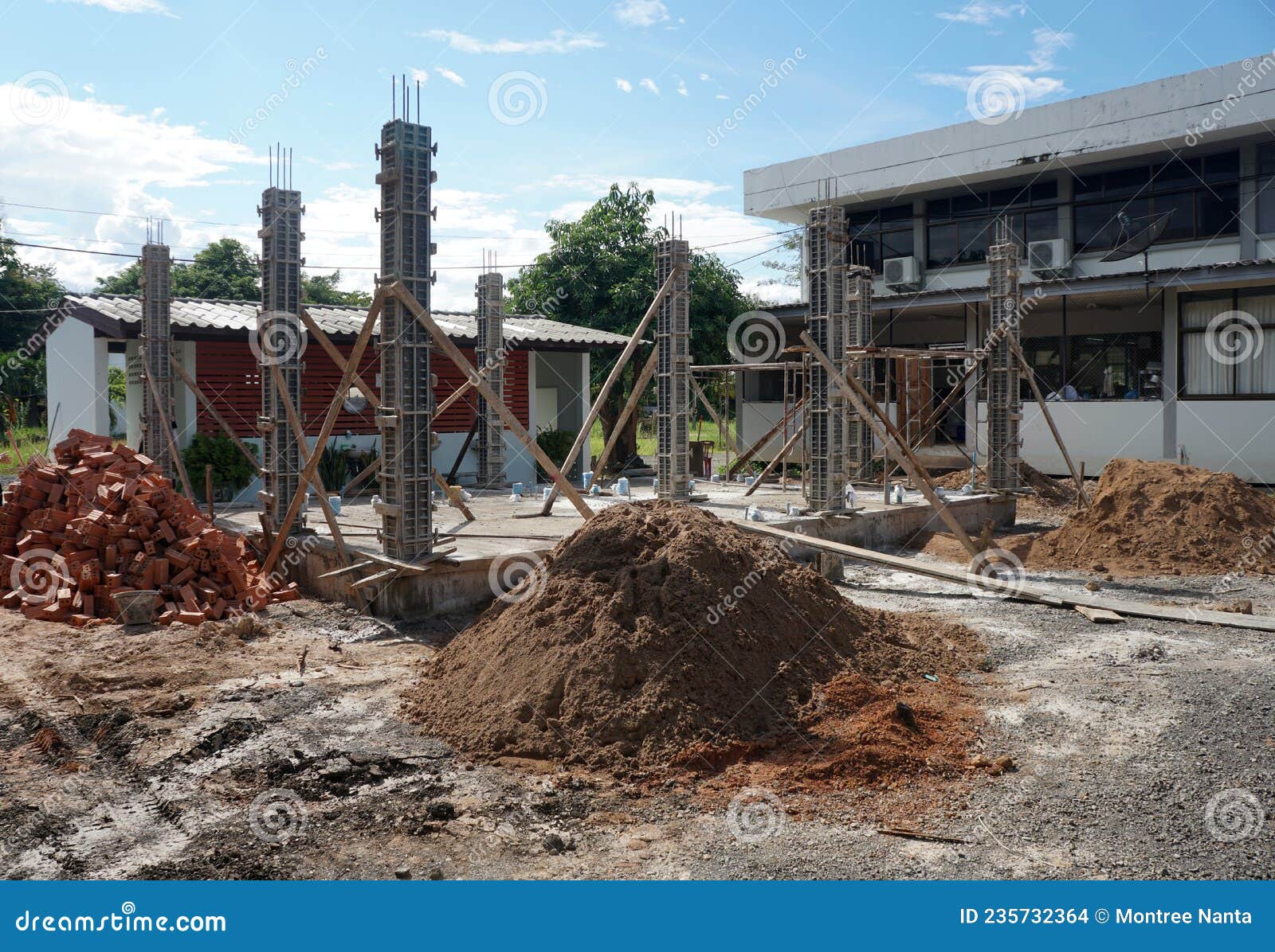 Steel Binding and Pole Entry on Construction Site with a Pile of Sand ...