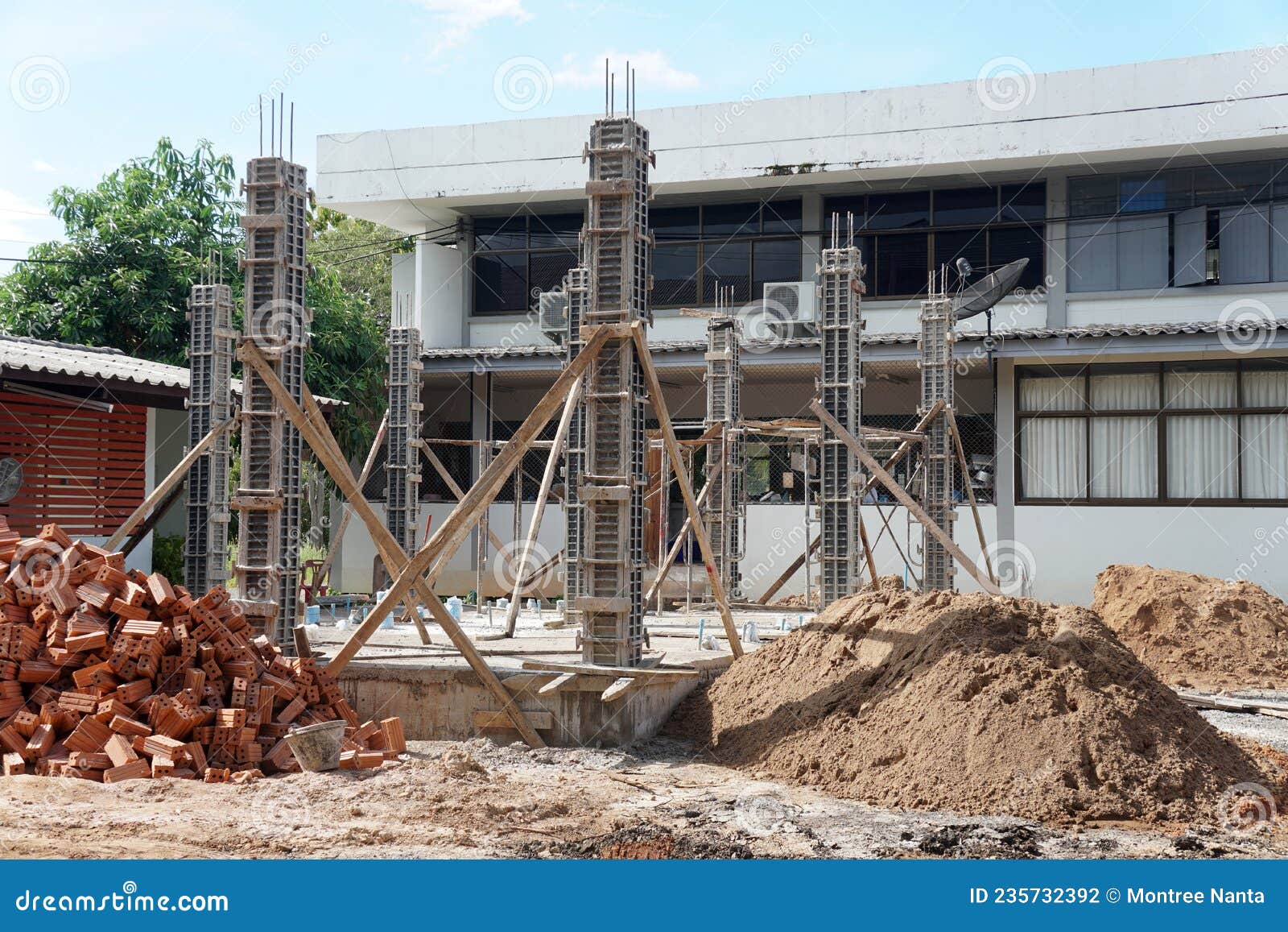 Steel Binding and Pole Entry on Construction Site with a Pile of Sand ...