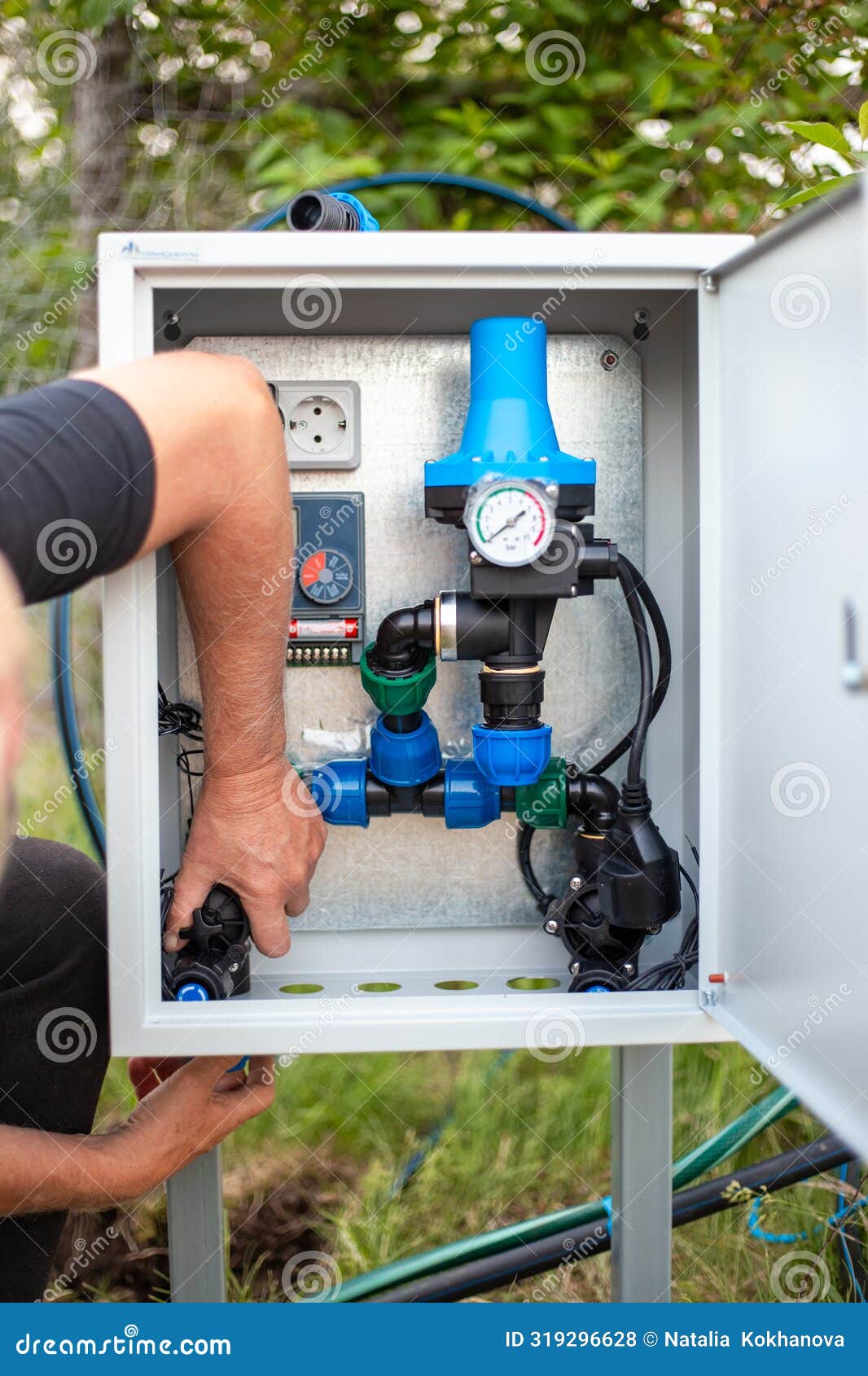Assembling an Automatic Water Supply System for Drip Irrigation. a Man ...