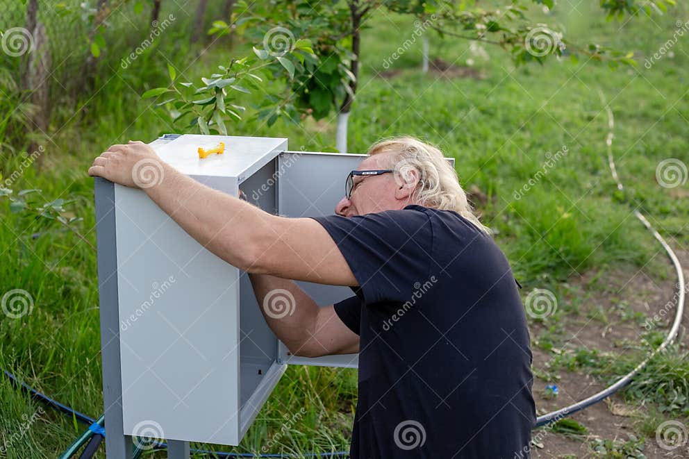 Assembling an Automatic Water Supply System for Drip Irrigation. a Man ...