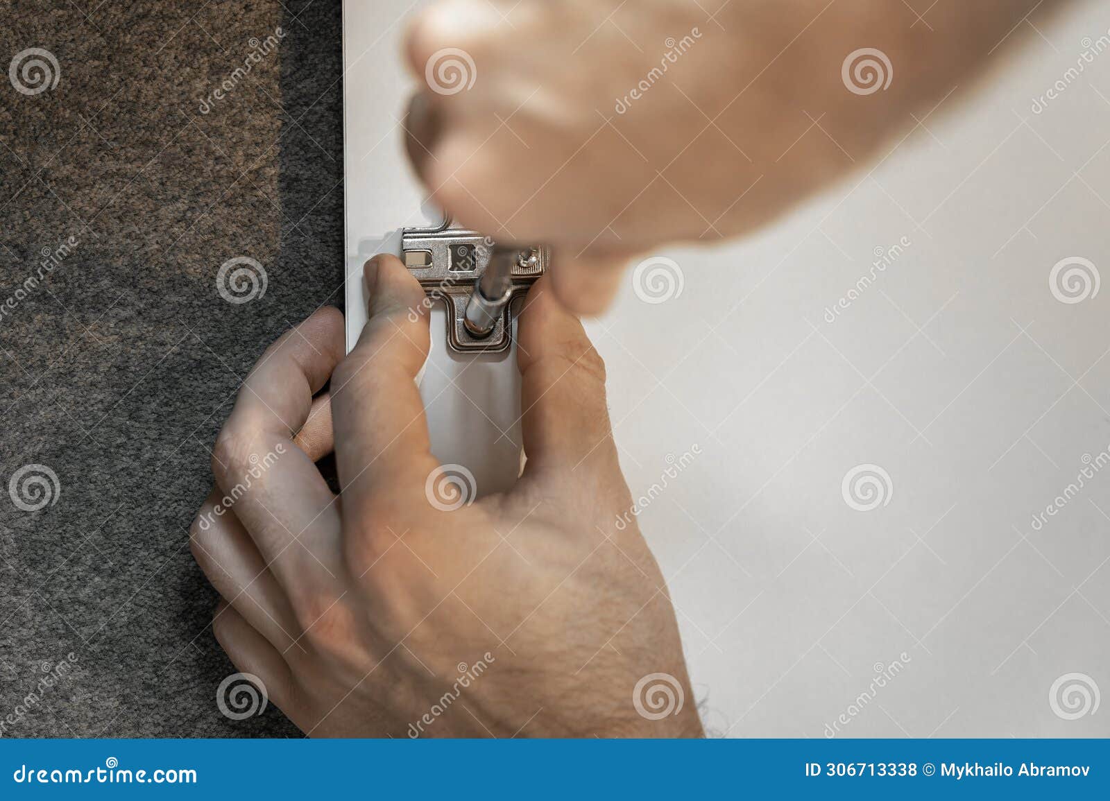 Assembling Furniture At Home Tightening The Bolt With A Screwdriver