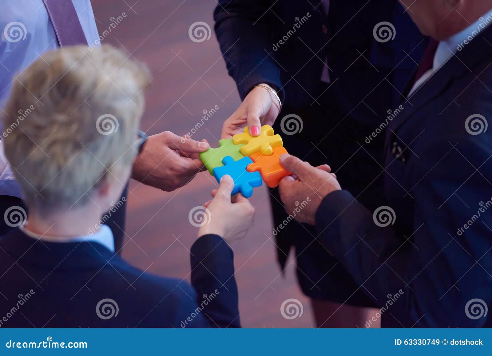 Assembling jigsaw puzzle stock image. Image of group - 63330749