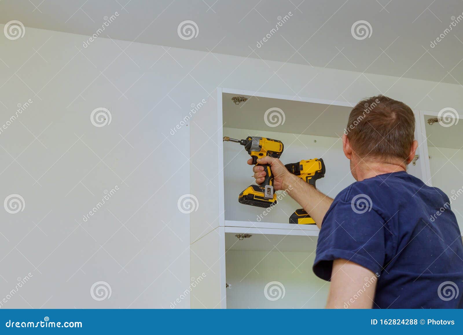 Assembling New Custom Kitchen in Various Stages of Installation Wall ...