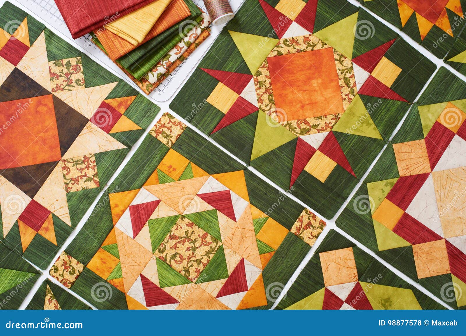 Assembling of Quilt from Orange-green Patchwork Blocks, Pile of Fabric ...