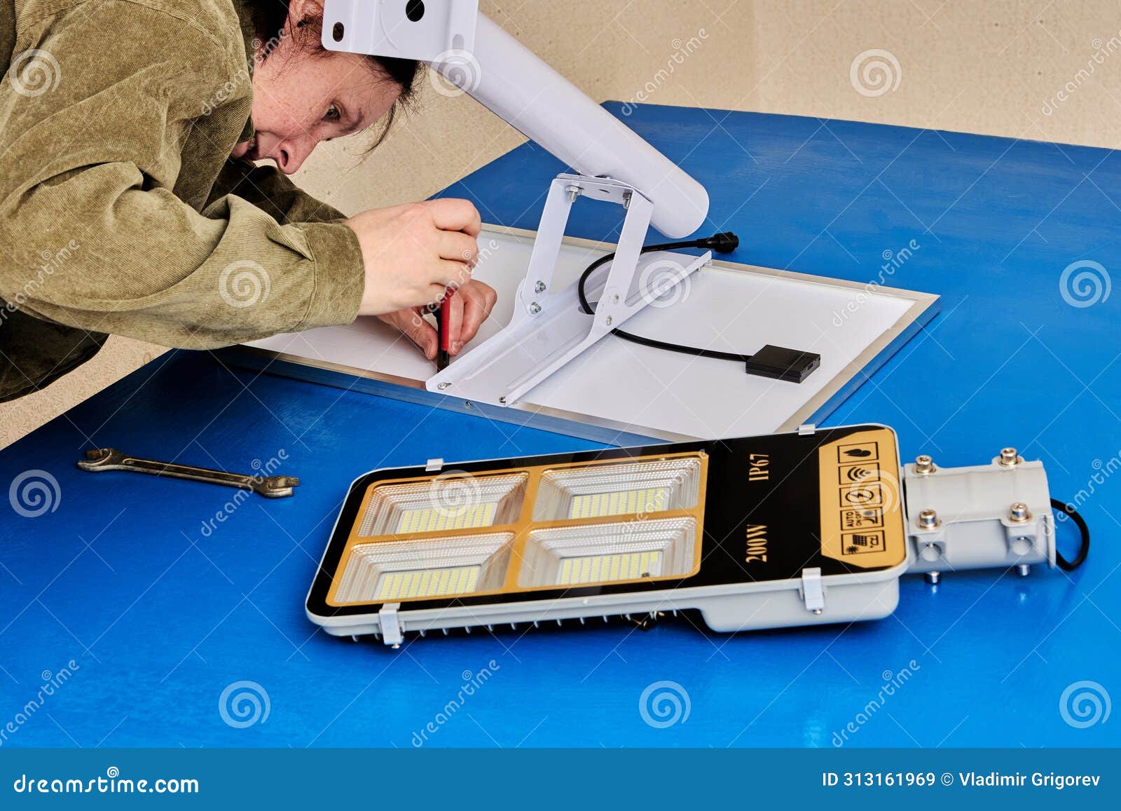 Assembling Stand Alone Solar Street Light, an Electrician Attaches ...