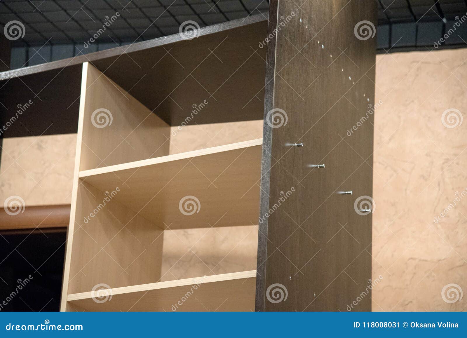 Assembling A Wooden Cabinet At Home Using A Drill And A Screwdriver
