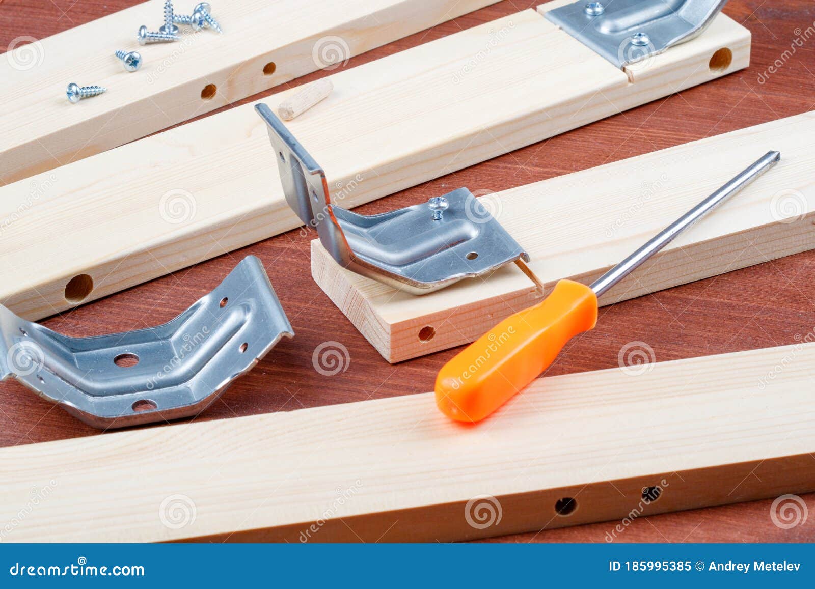 Assembling a Wooden Table with Tools and Screws on a Cardboard Surface ...