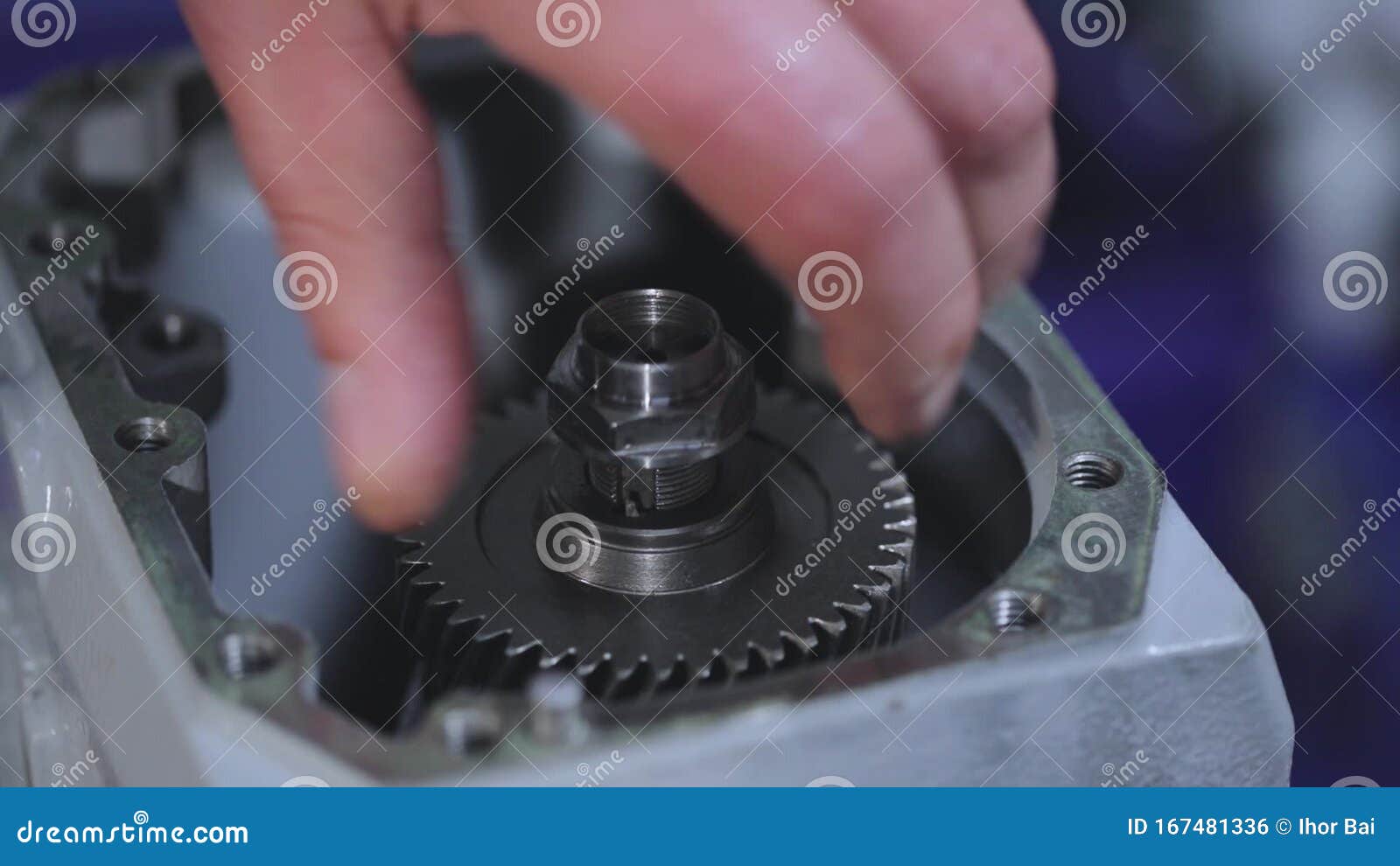 Assembly of the Gearbox, Man Inserts the Gear into the Gearbox. Metal ...