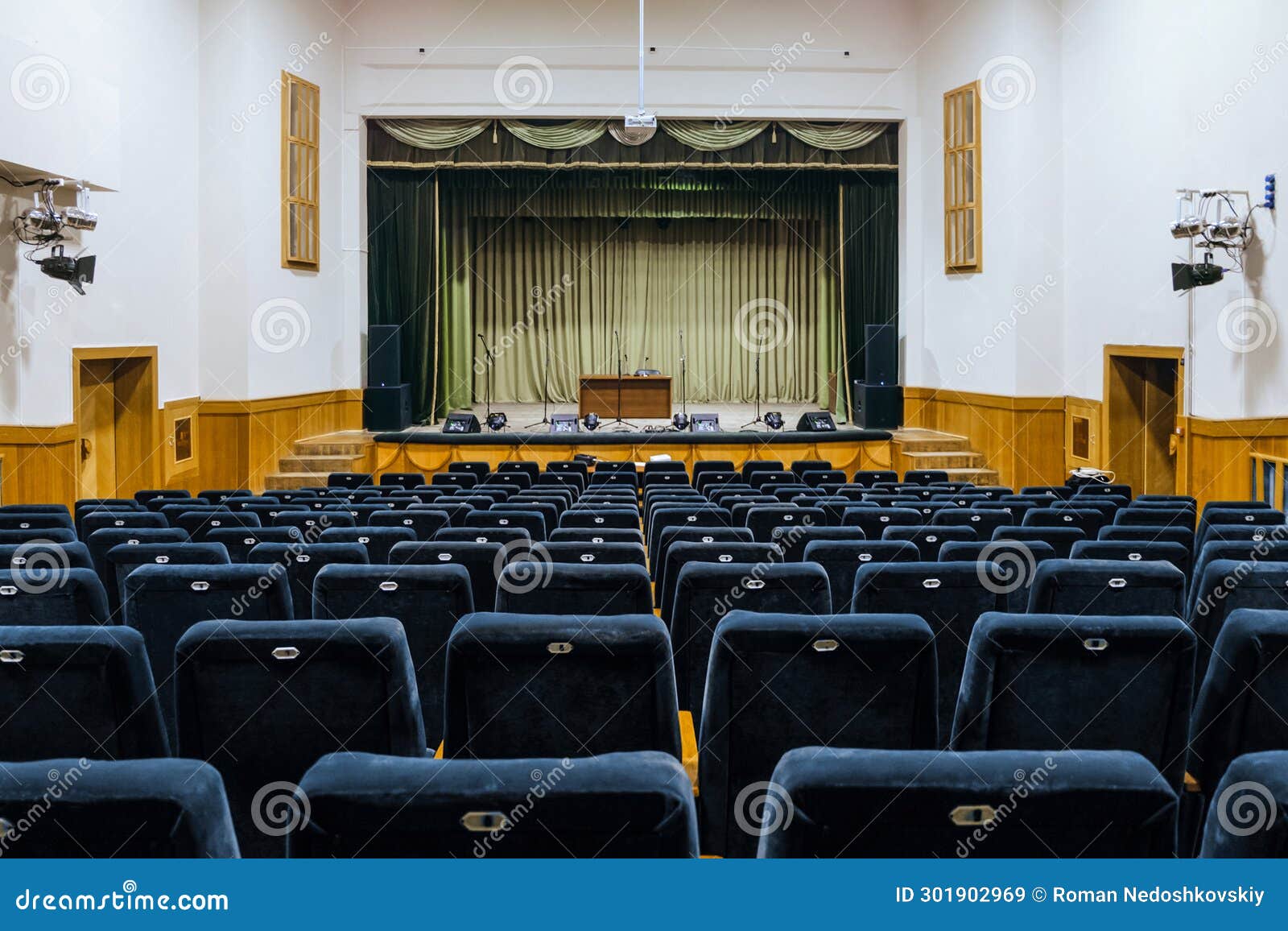 Assembly Hall with Stage for Performance and Rows of Empty Dark Blue ...