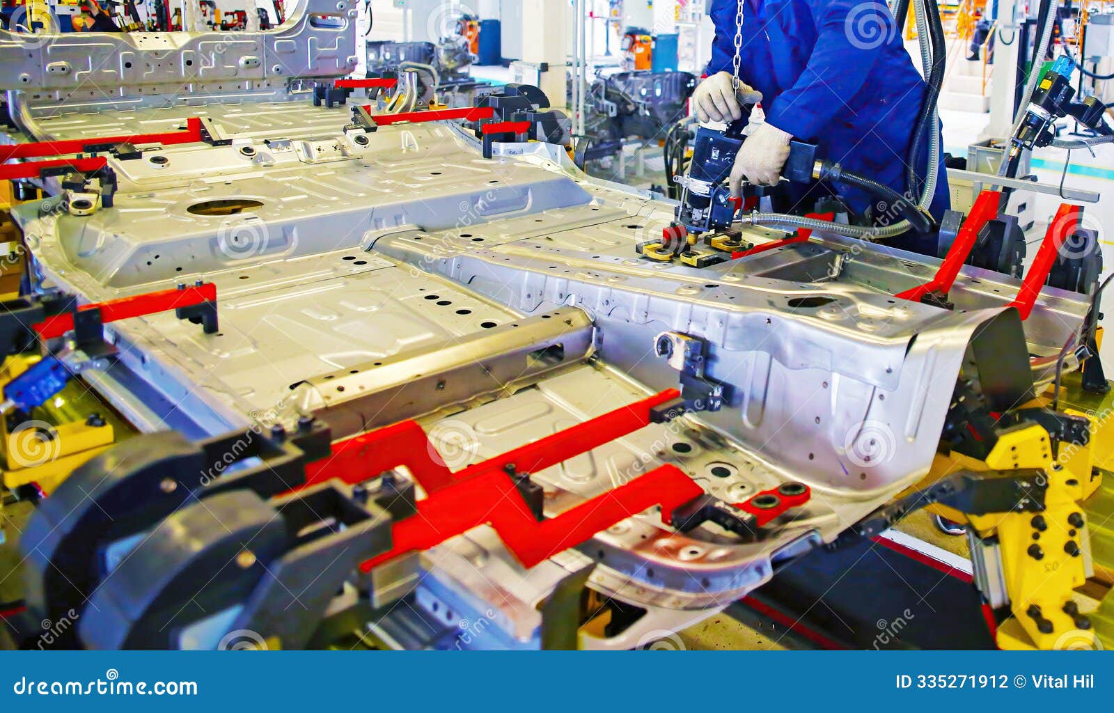Assembly Workers are Constructing an Automotive Chassis at a ...