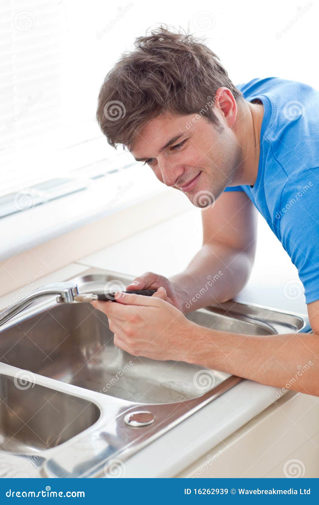 Assertive Man Repairing His Sink in the Kitchen Stock Image - Image of ...