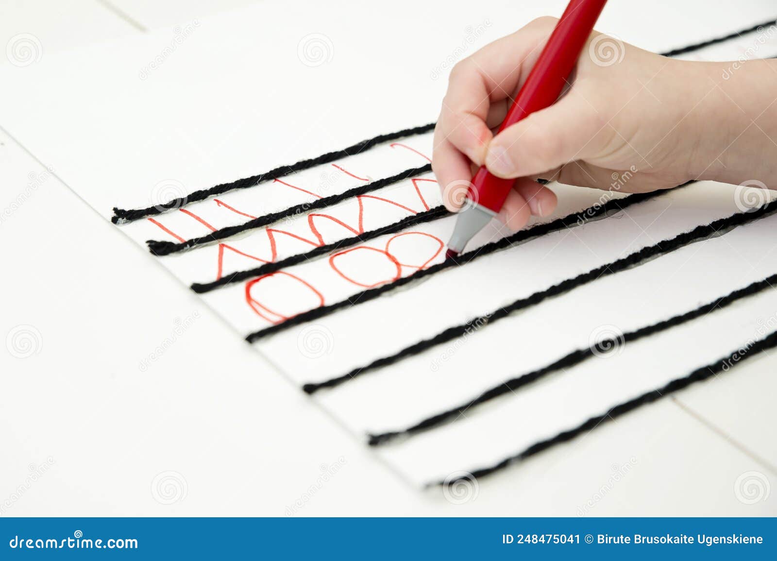 Child Learns To Write Symbols. Hand Training Tasks. Stock Image - Image ...