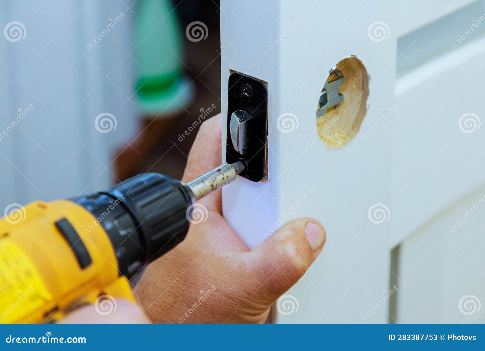 With Assistance of a Screwdriver Worker Completes Installation of Lock ...