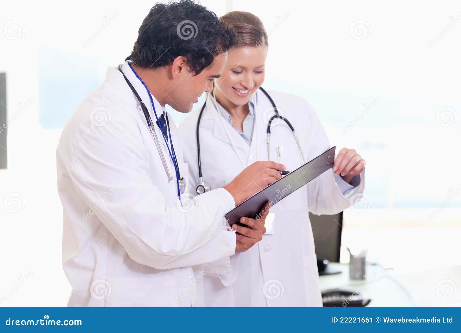 Assistant Doctors Reading Off Clip Board Stock Image - Image of ...