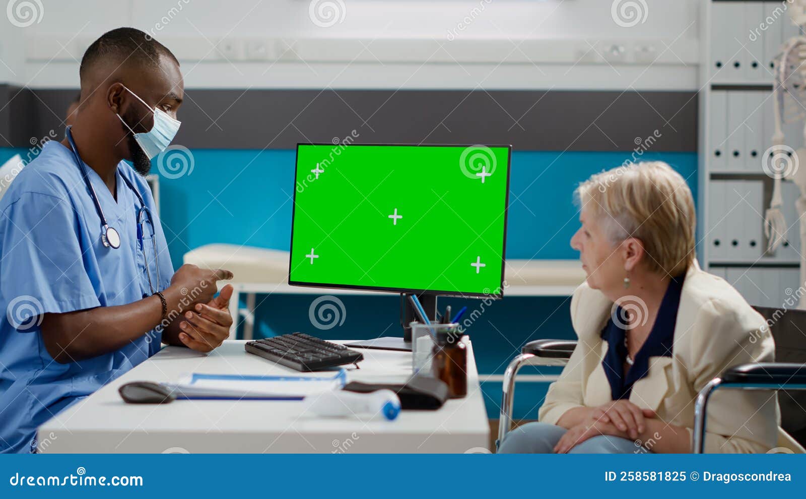 Assistant with Face Mask and Woman in Wheelchair Using Greenscreen ...