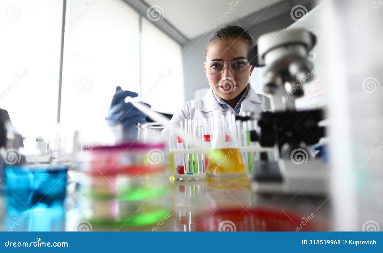Assistant Pouring Liquid into Flask Stock Photo - Image of work ...