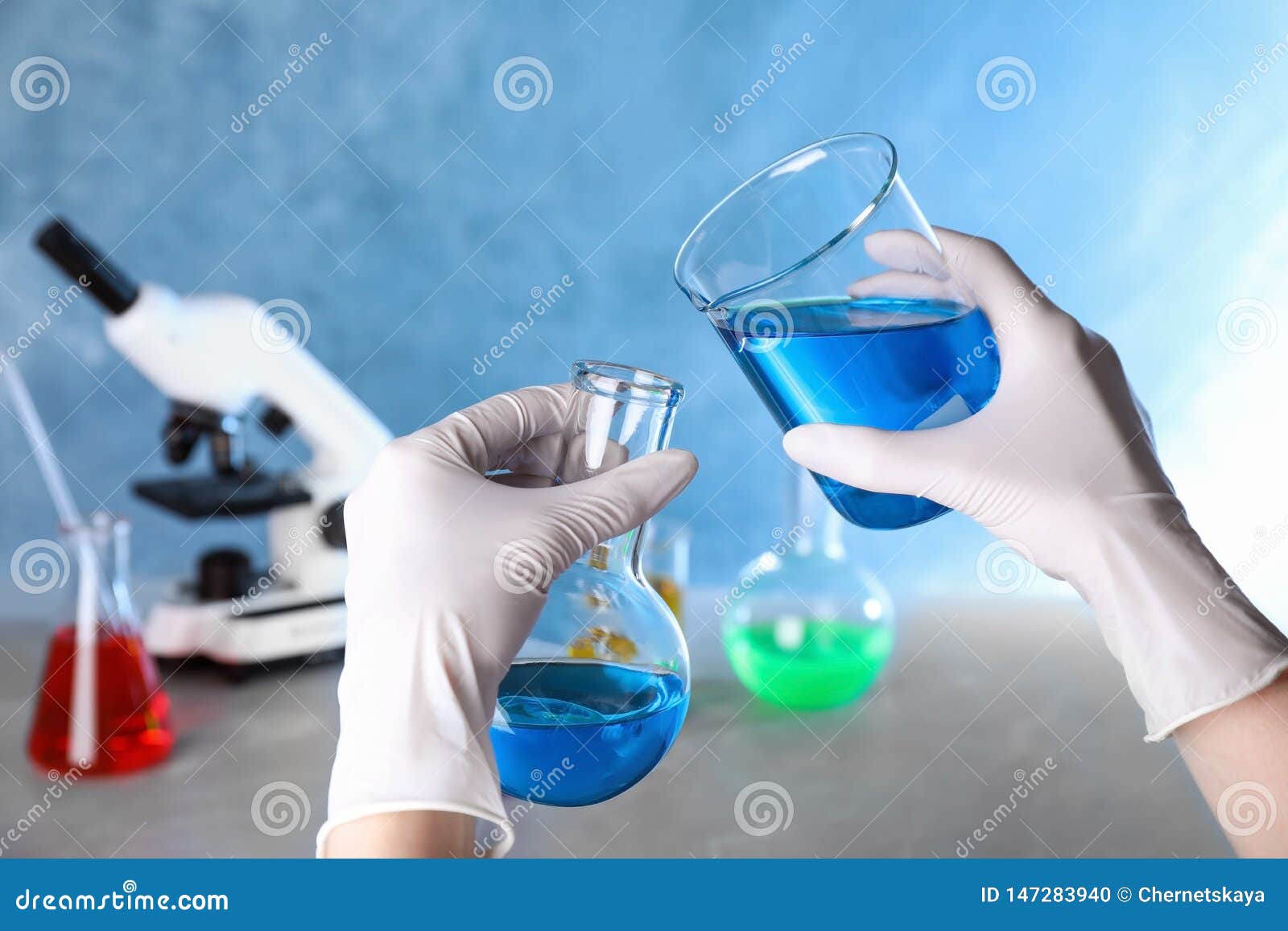 Assistant Pouring Sample into Glass Flask in Chemistry Laboratory Stock ...