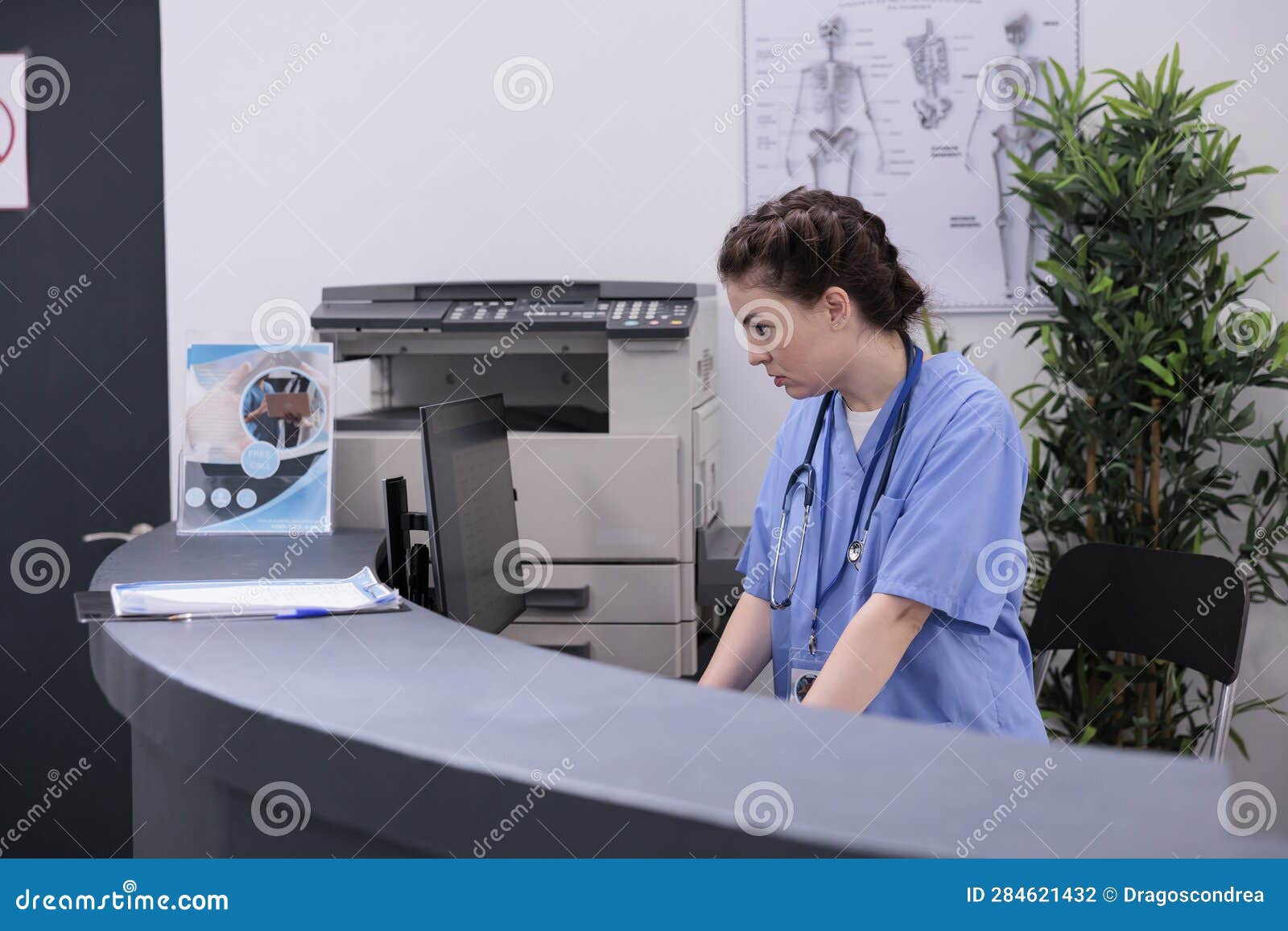 Assistant Working at Reception Counter Checking Medical Expertise on ...