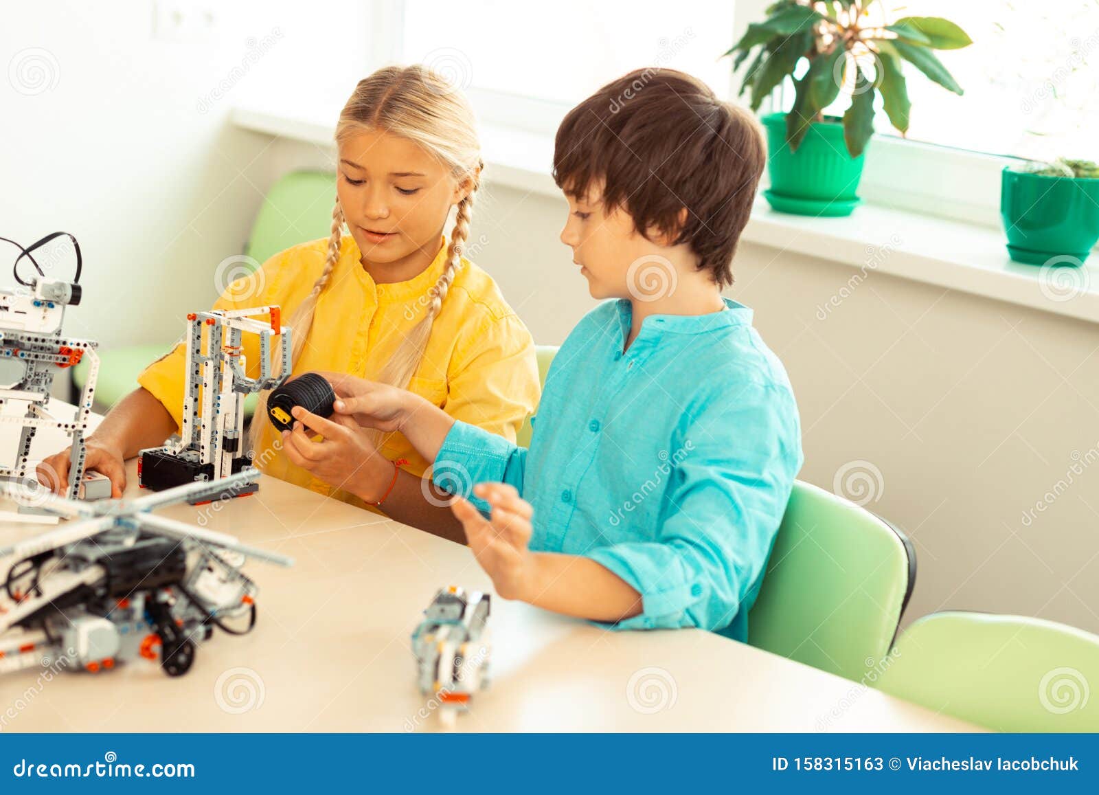 Boy Helping His Classmate with Her Project. Stock Image - Image of ...