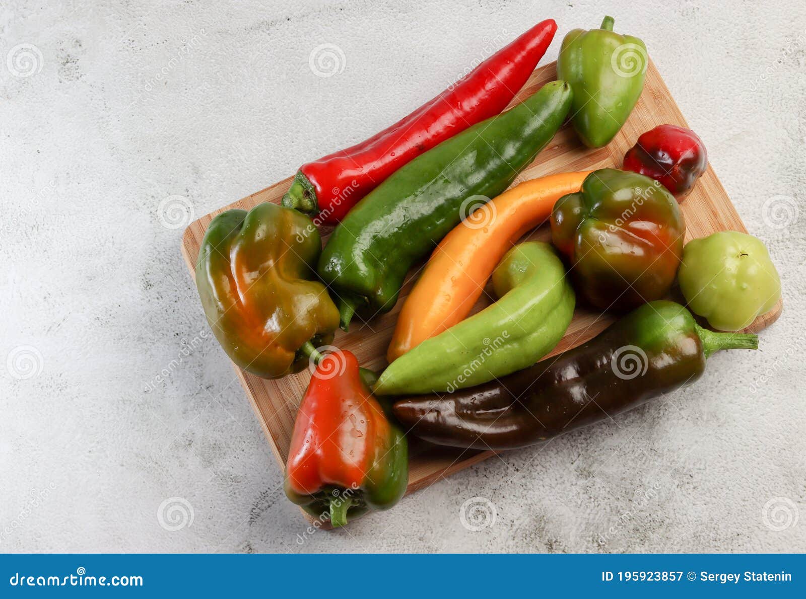 Assorted Bell Peppers on a Rectangular Cutting Wooden Board on a Light ...