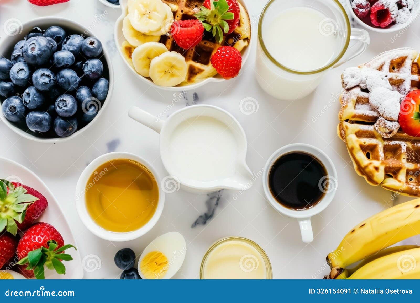 Assorted Breakfast Items Including Waffles, Fruits, Milk, Coffee, and ...