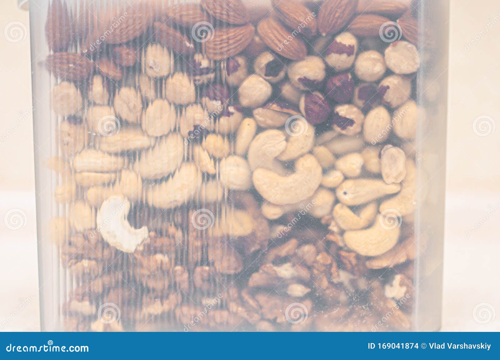 Assorted Cashews, Almonds, Greta and Hazelnuts in a Plastic Container ...